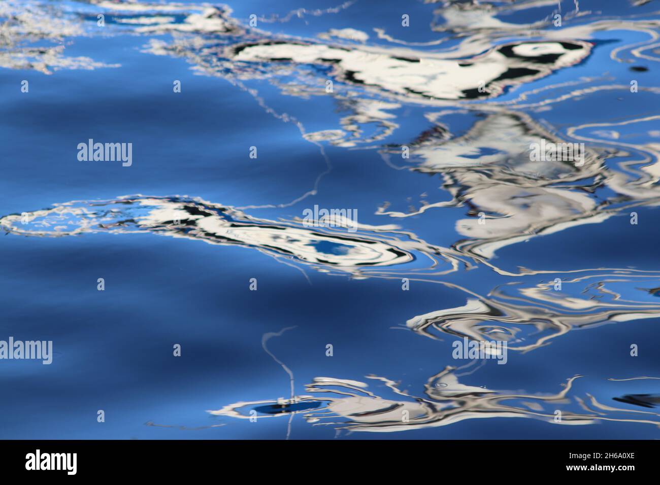 Patterns and colours in reflections of boats in harbour water Stock ...