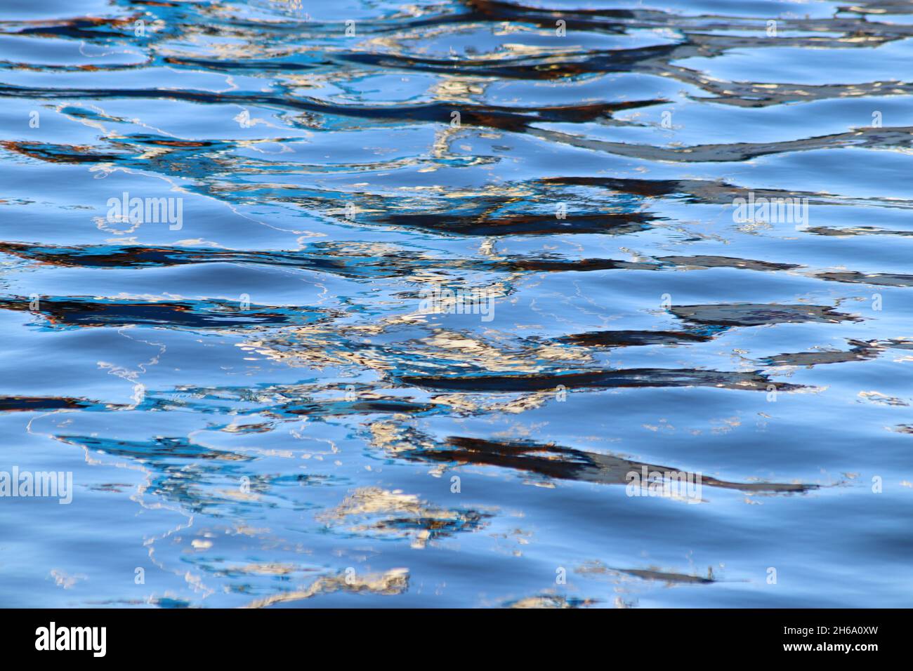 Patterns and colours in reflections of boats in harbour water Stock ...