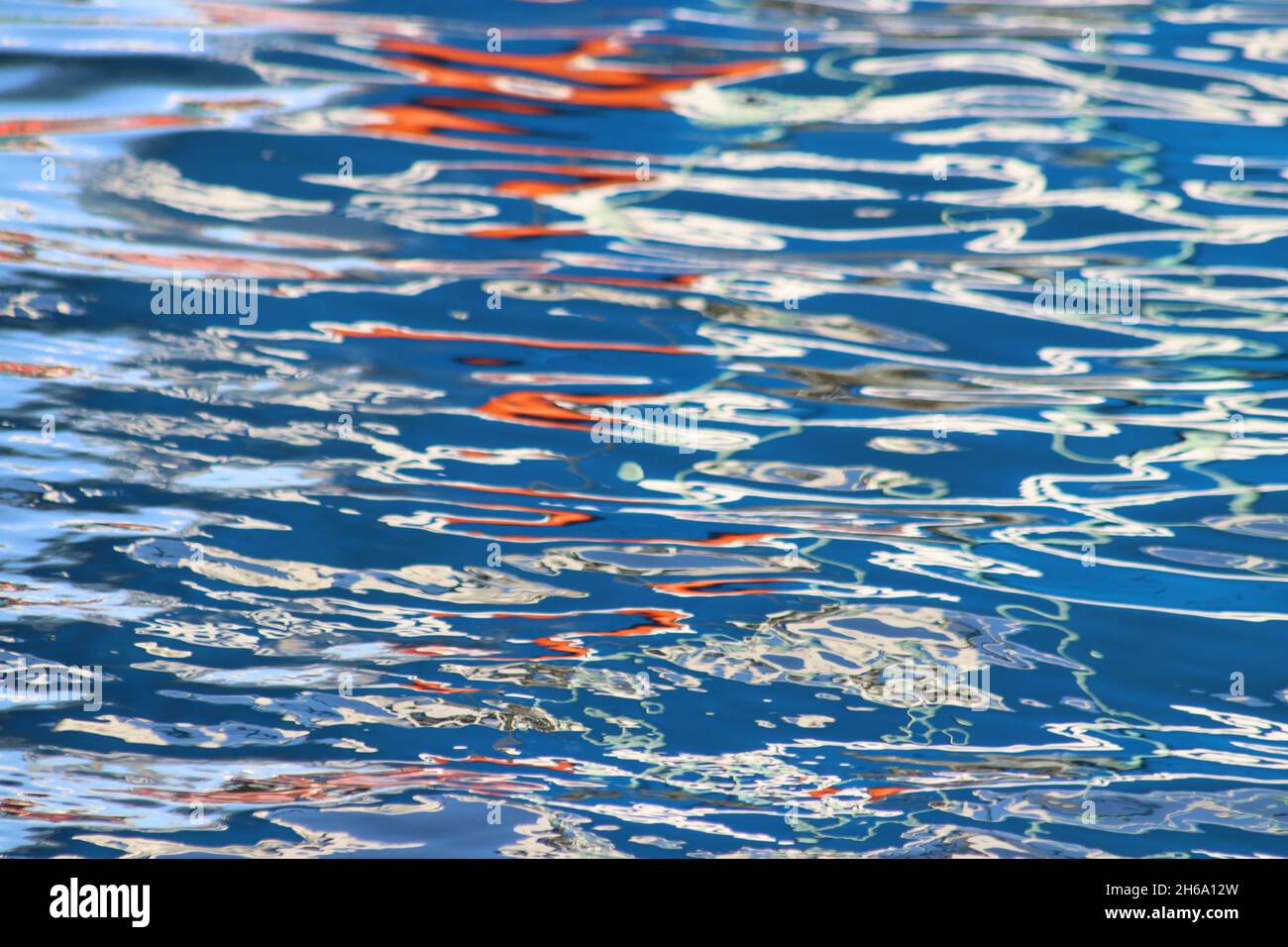 Patterns and colours in reflections of boats in harbour water Stock ...