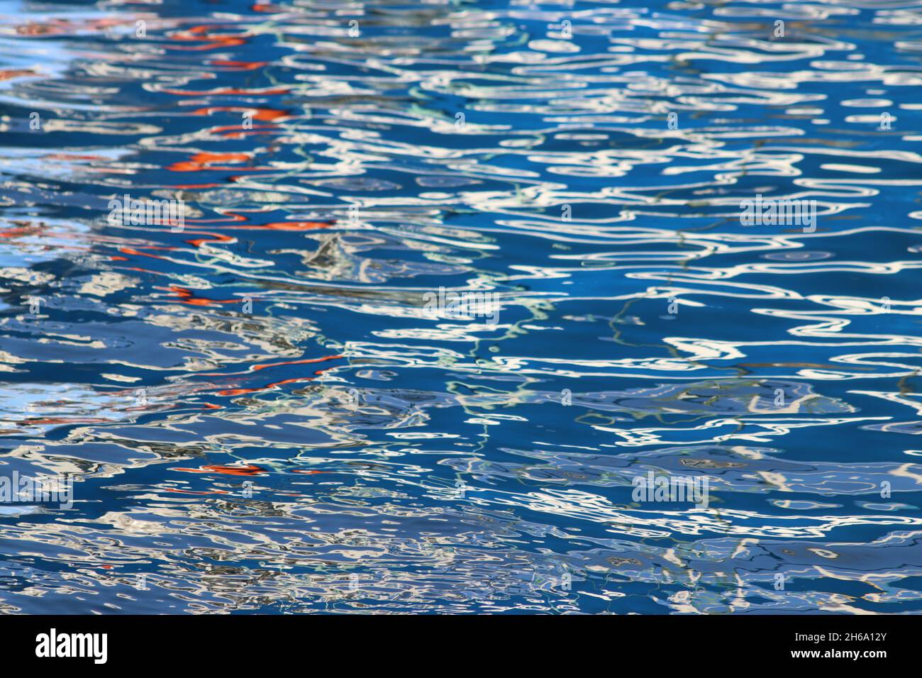 Patterns and colours in reflections of boats in harbour water Stock ...