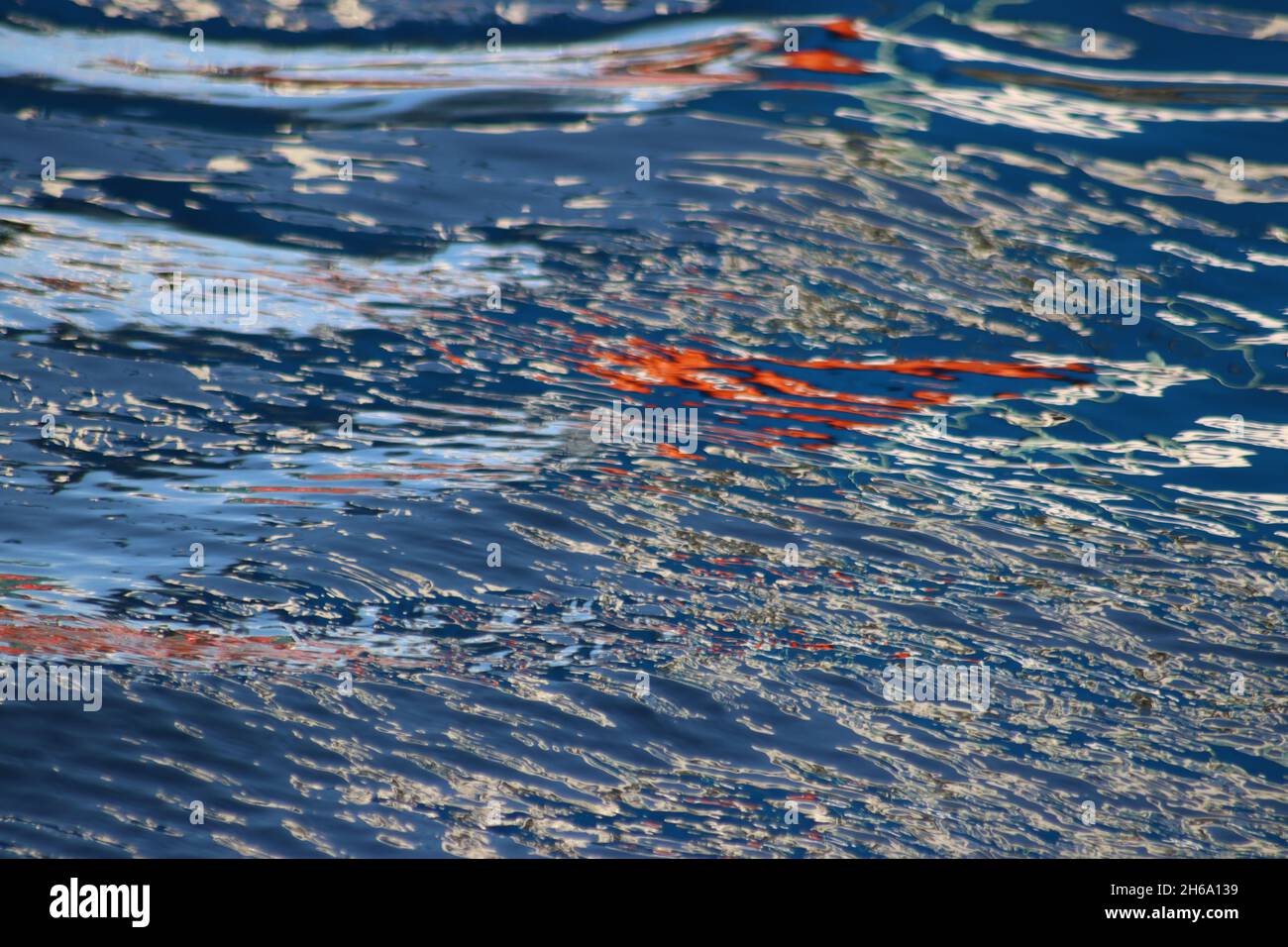 Patterns and colours in reflections of boats in harbour water Stock ...