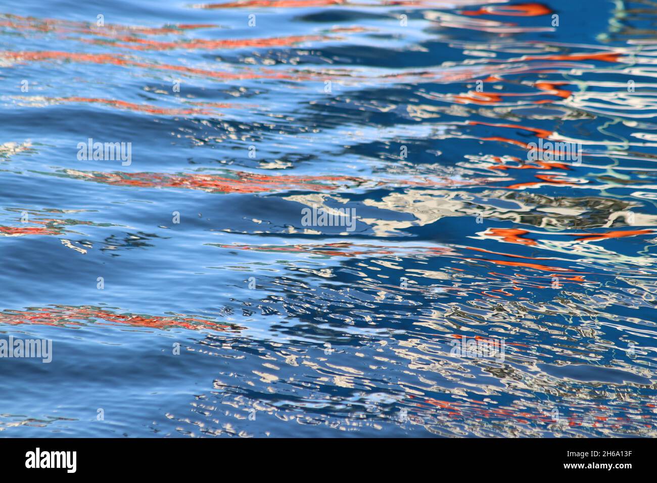Patterns and colours in reflections of boats in harbour water Stock ...