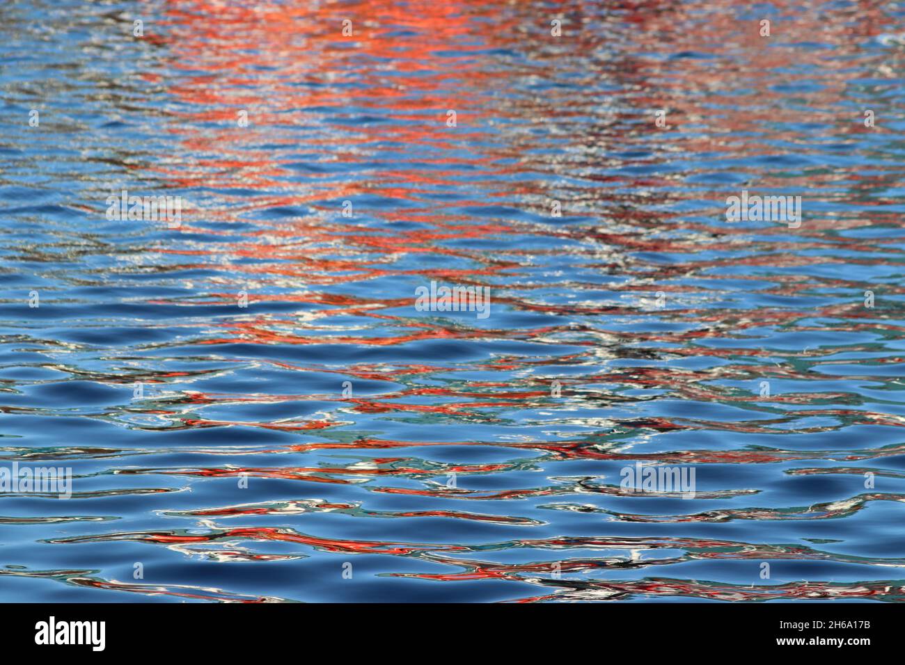 Patterns and colours in reflections of boats in harbour water Stock ...