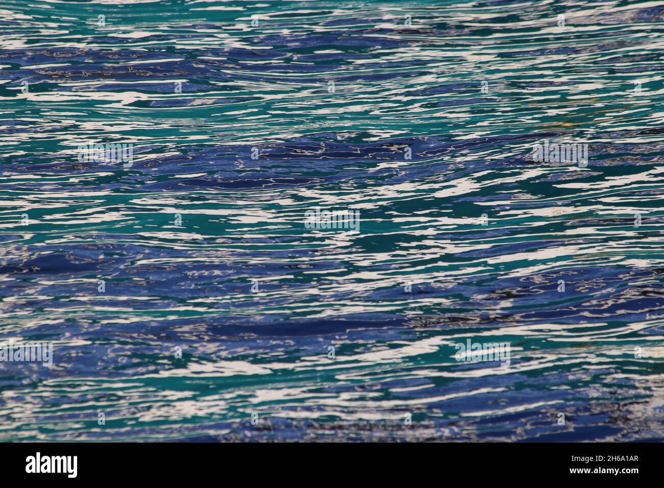 Patterns and colours in reflections of boats in harbour water Stock ...