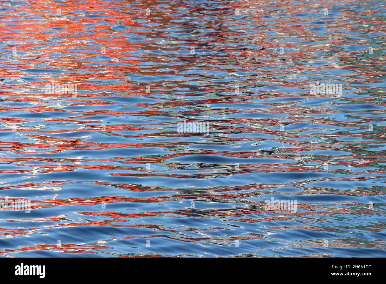 Patterns and colours in reflections of boats in harbour water Stock ...