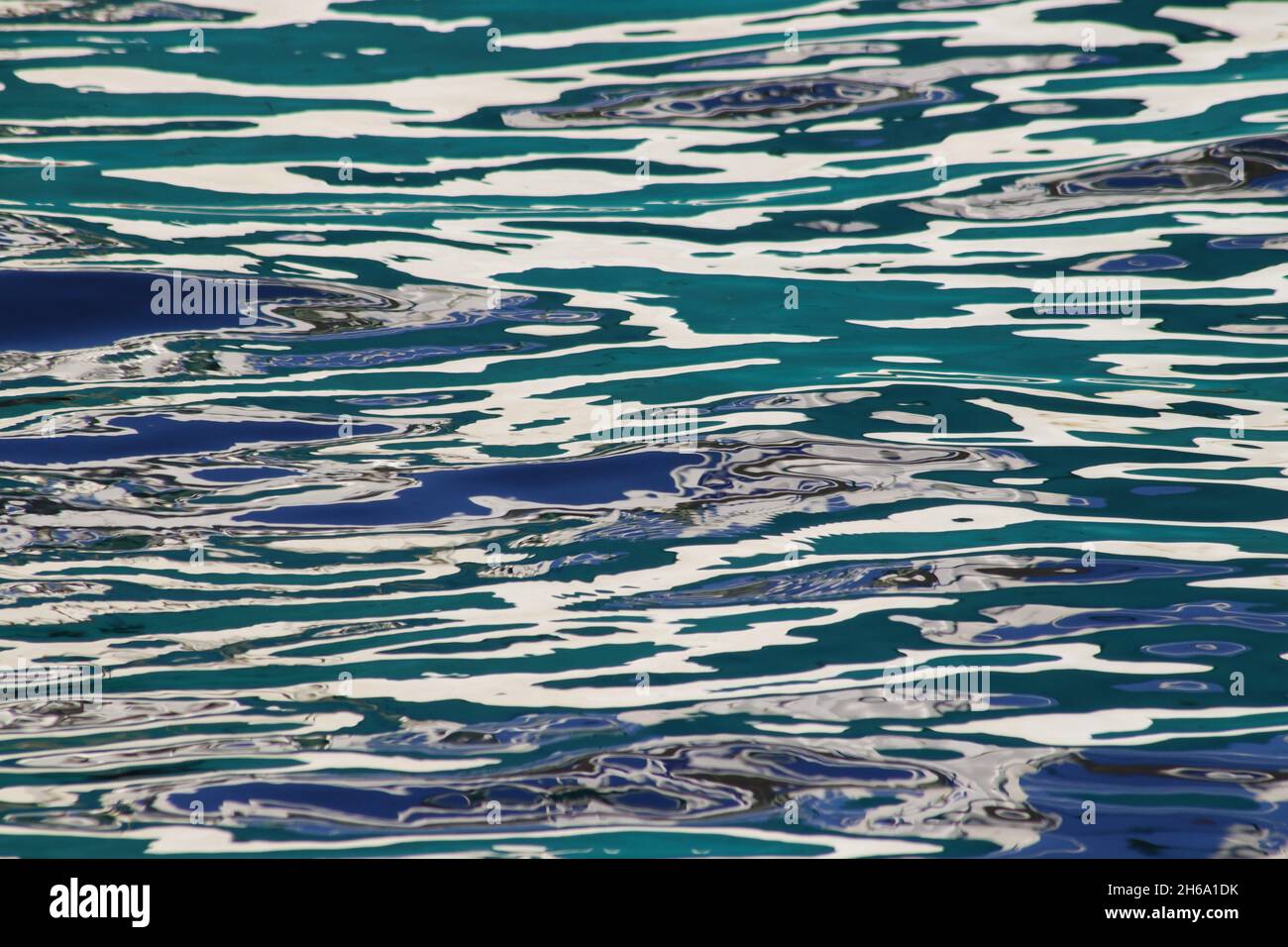 Patterns and colours in reflections of boats in harbour water Stock ...