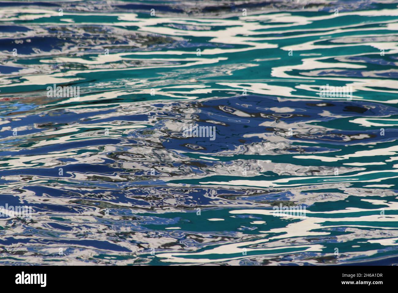 Patterns and colours in reflections of boats in harbour water Stock ...