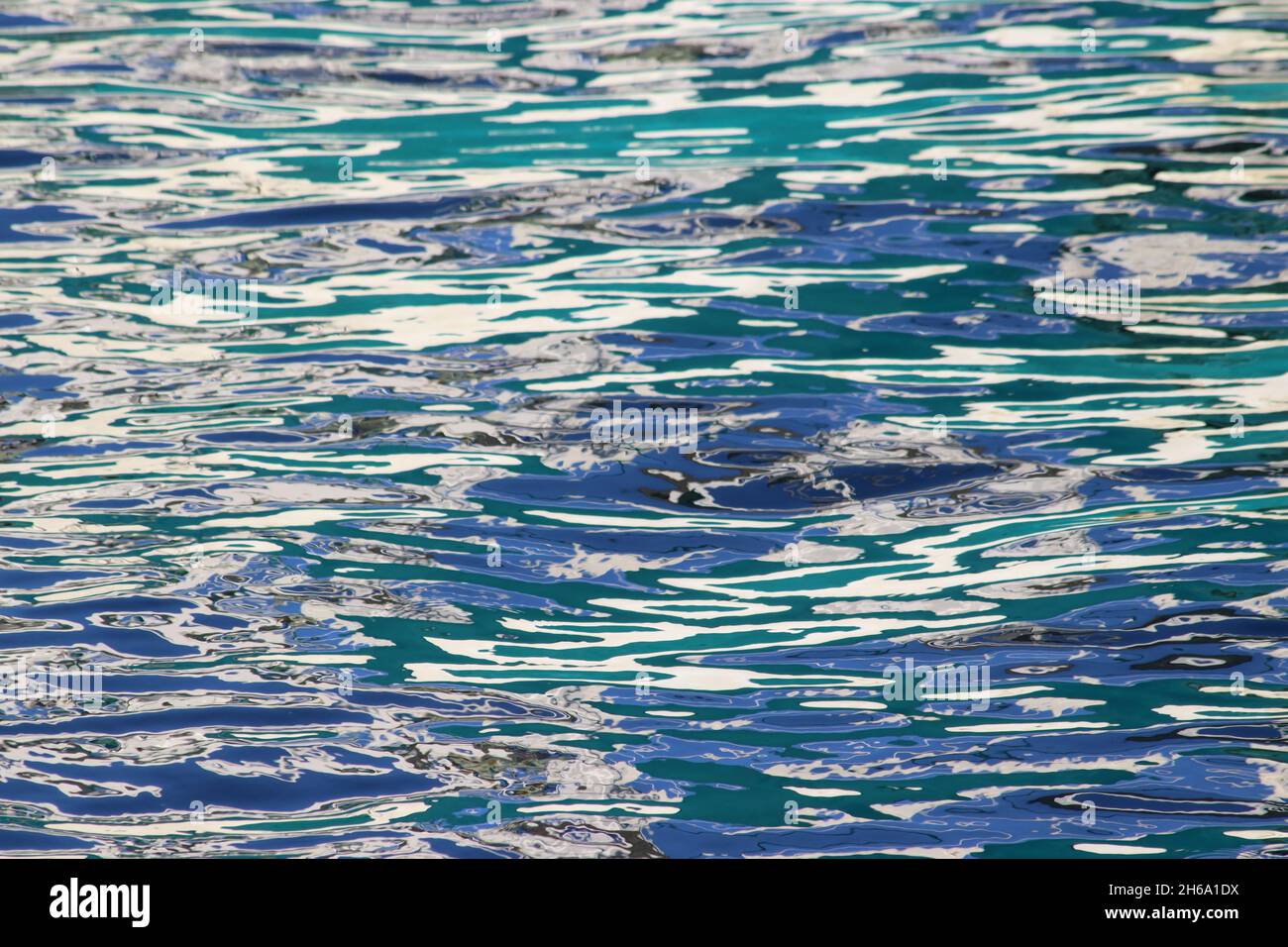 Patterns and colours in reflections of boats in harbour water Stock ...
