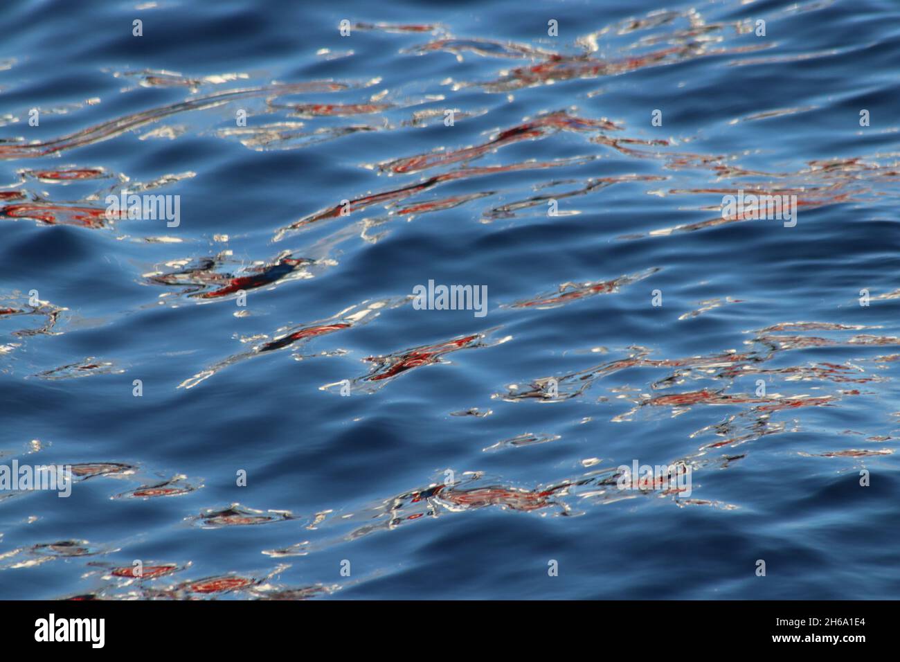 Patterns and colours in reflections of boats in harbour water Stock ...