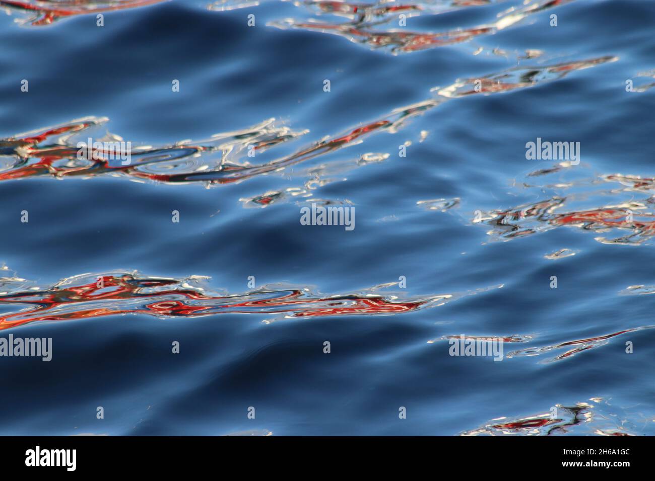 Patterns and colours in reflections of boats in harbour water Stock ...