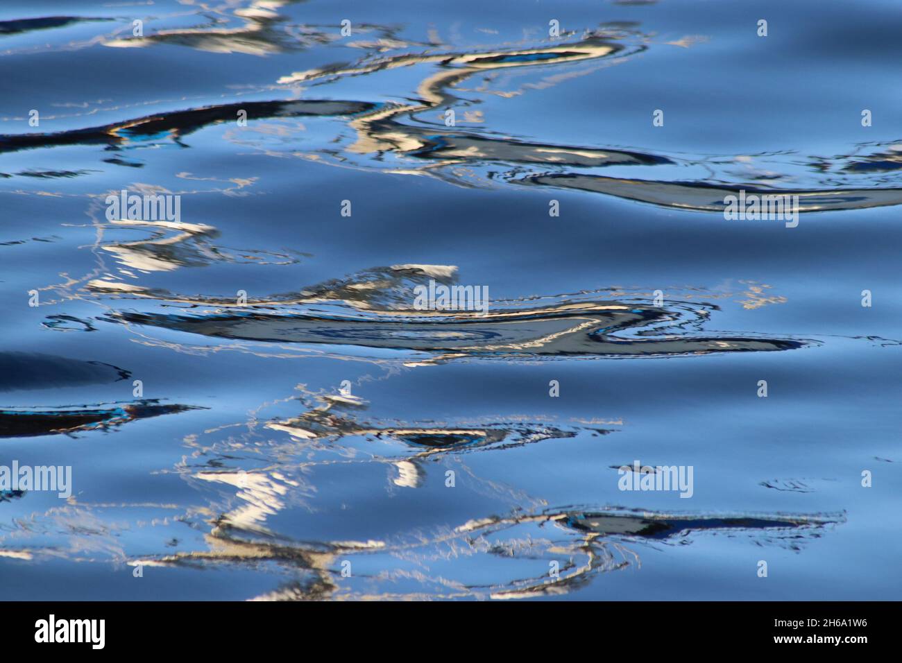 Patterns and colours in reflections of boats in harbour water Stock ...
