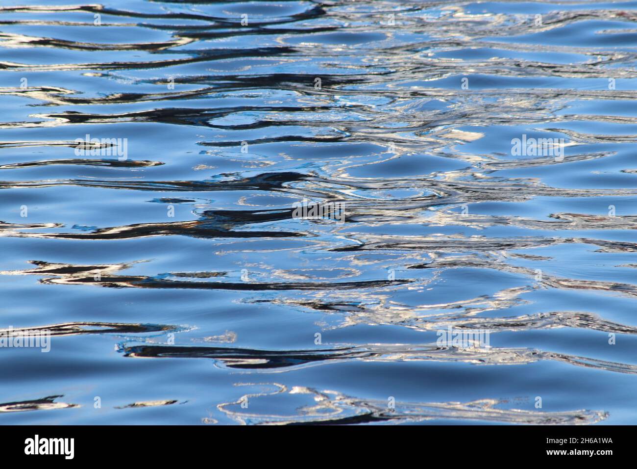 Patterns and colours in reflections of boats in harbour water Stock ...