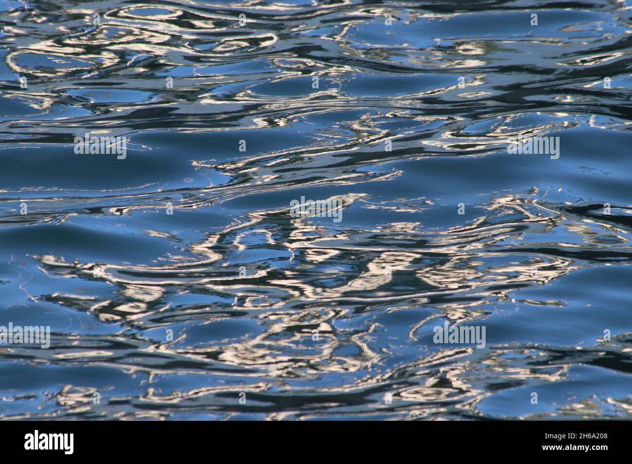 Patterns and colours in reflections of boats in harbour water Stock ...
