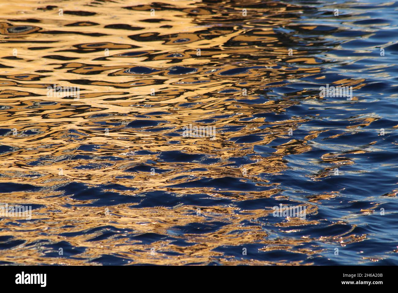 Patterns and colours in reflections of boats in harbour water Stock ...