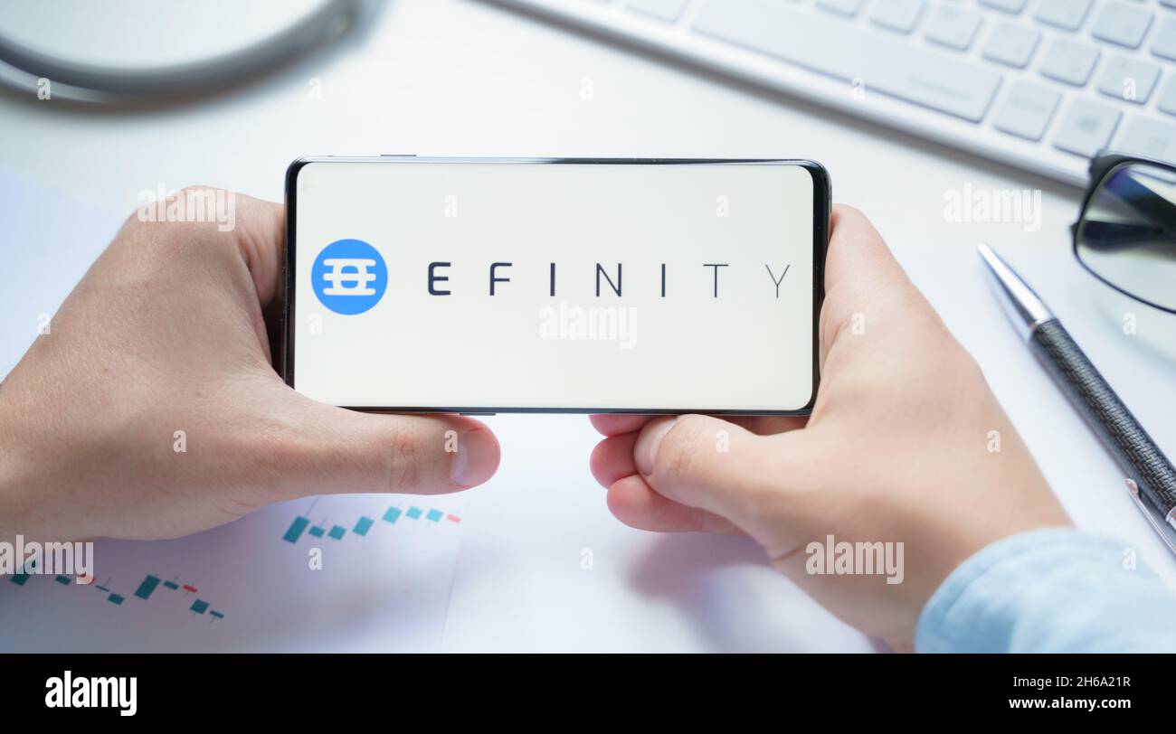 Russia, Moscow 08.06.2021. Mobile phone with logo of Efinity, EFI token. Next-generation ...