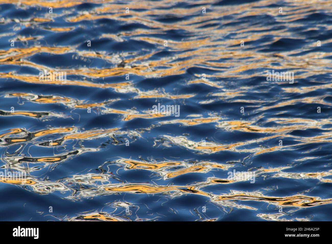 Patterns and colours in reflections of boats in harbour water Stock ...