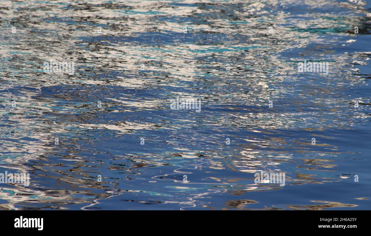Patterns and colours in reflections of boats in harbour water Stock ...