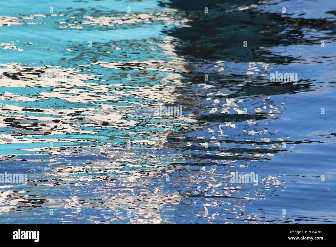Patterns and colours in reflections of boats in harbour water Stock ...