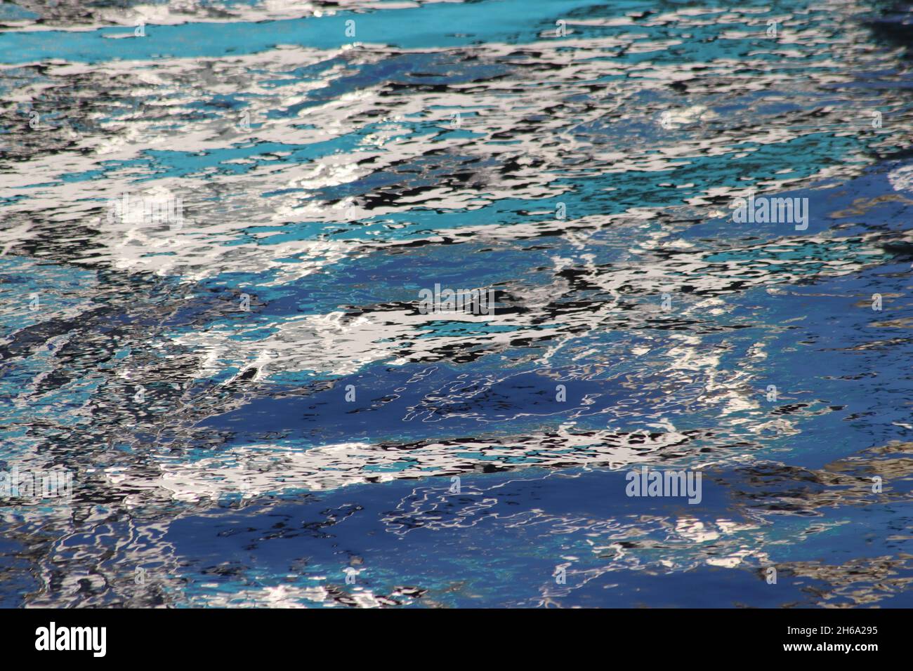 Patterns and colours in reflections of boats in harbour water Stock ...