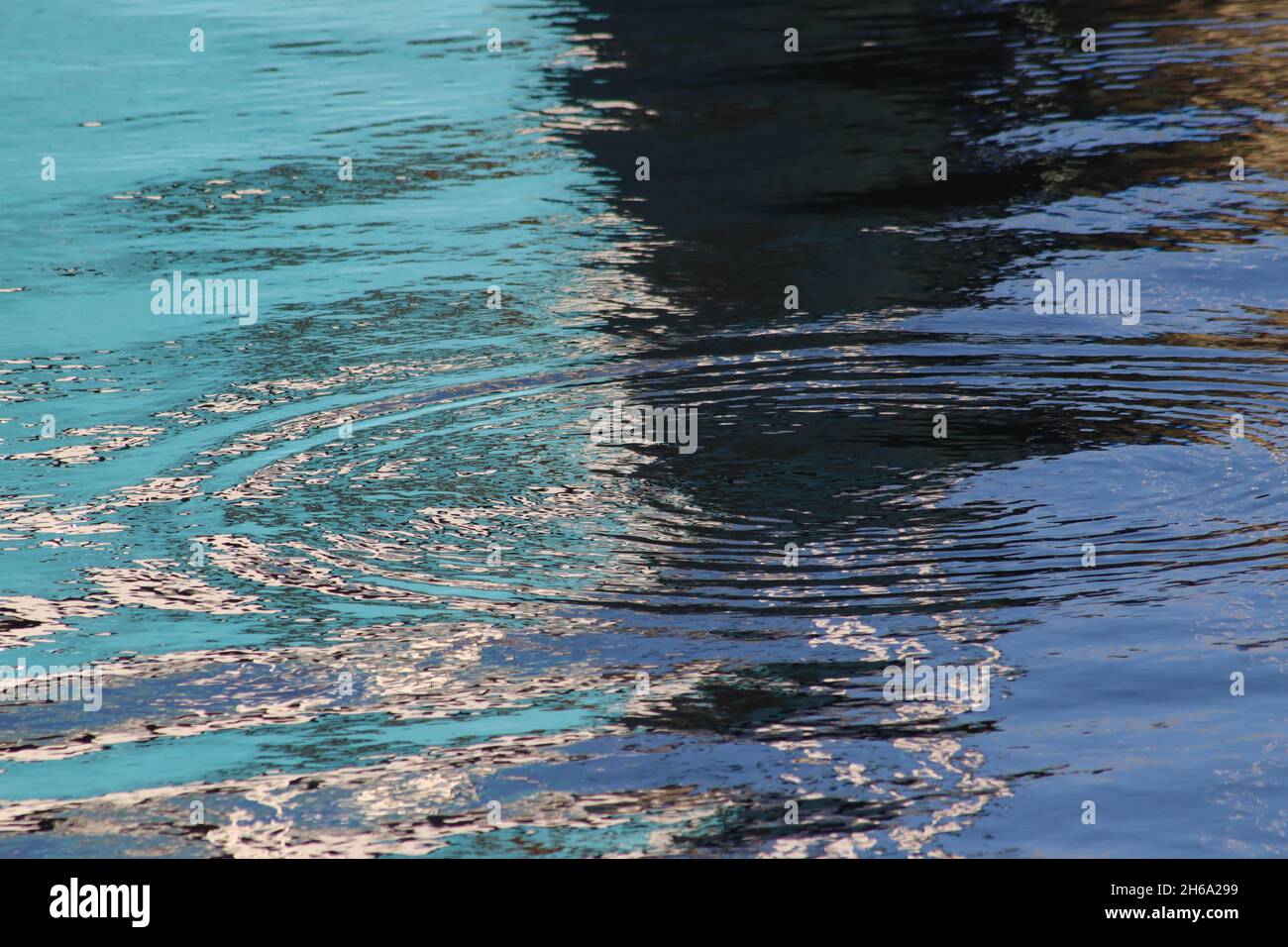 Patterns and colours in reflections of boats in harbour water Stock ...