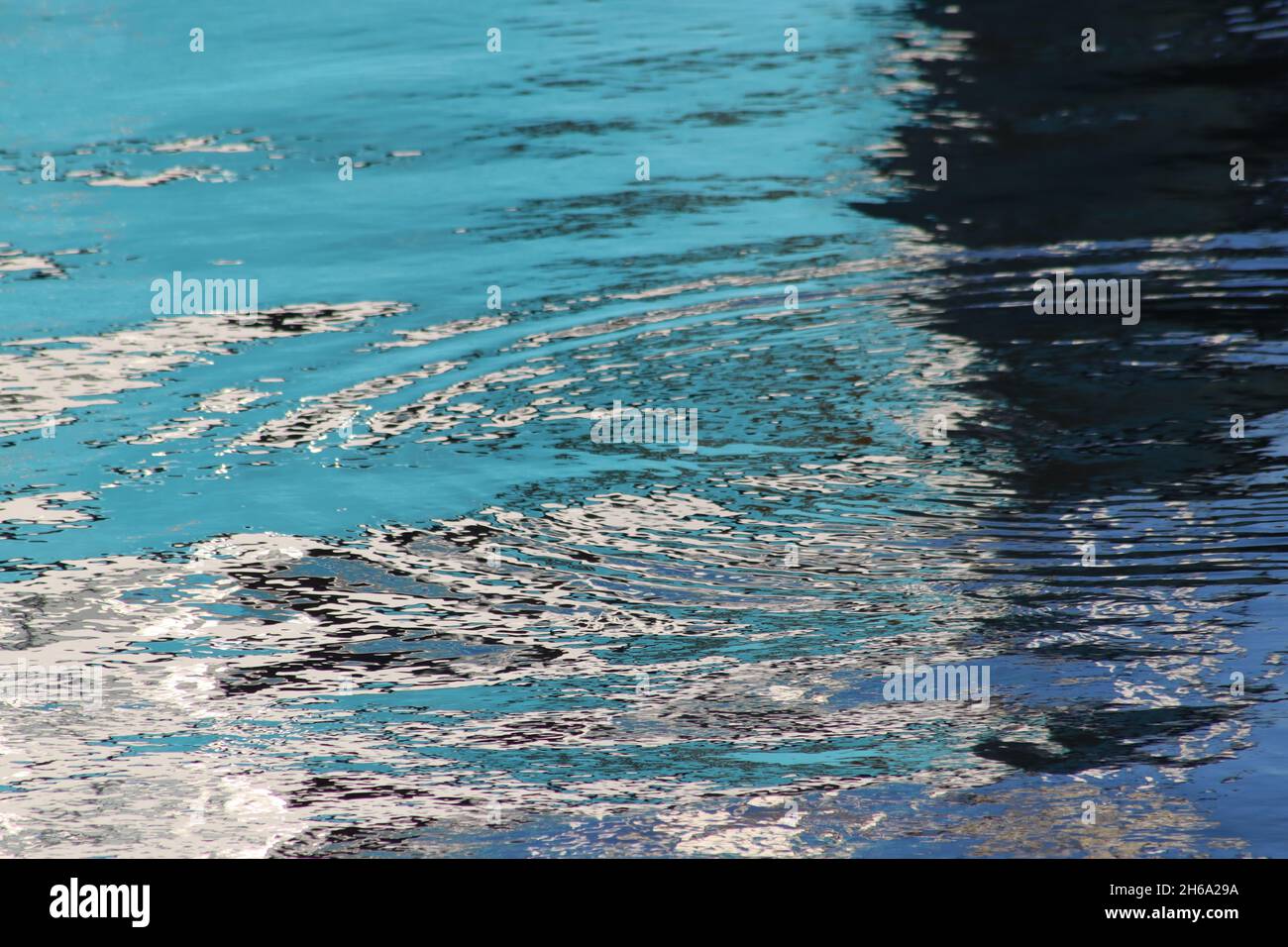 Patterns and colours in reflections of boats in harbour water Stock ...