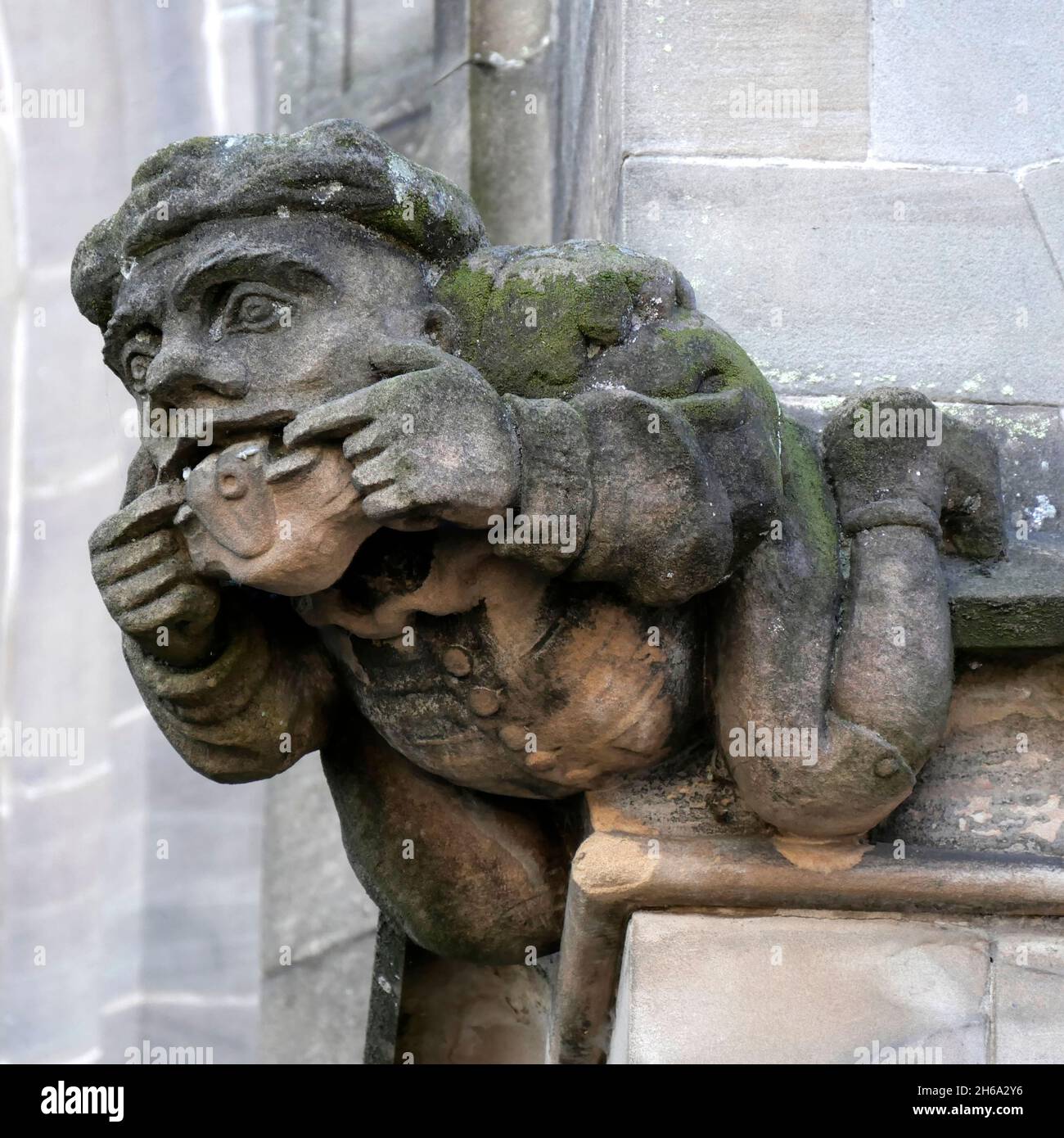 Gargoyle pulling mouth and sticking tongue out, on the Guild chapel ...