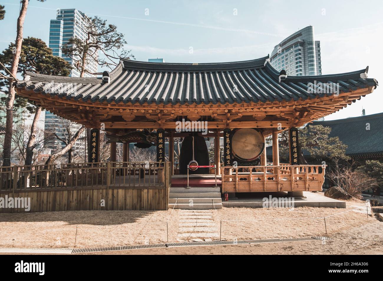 Traditional Asian temple with big roof in metropolis. skyscrapers on ...