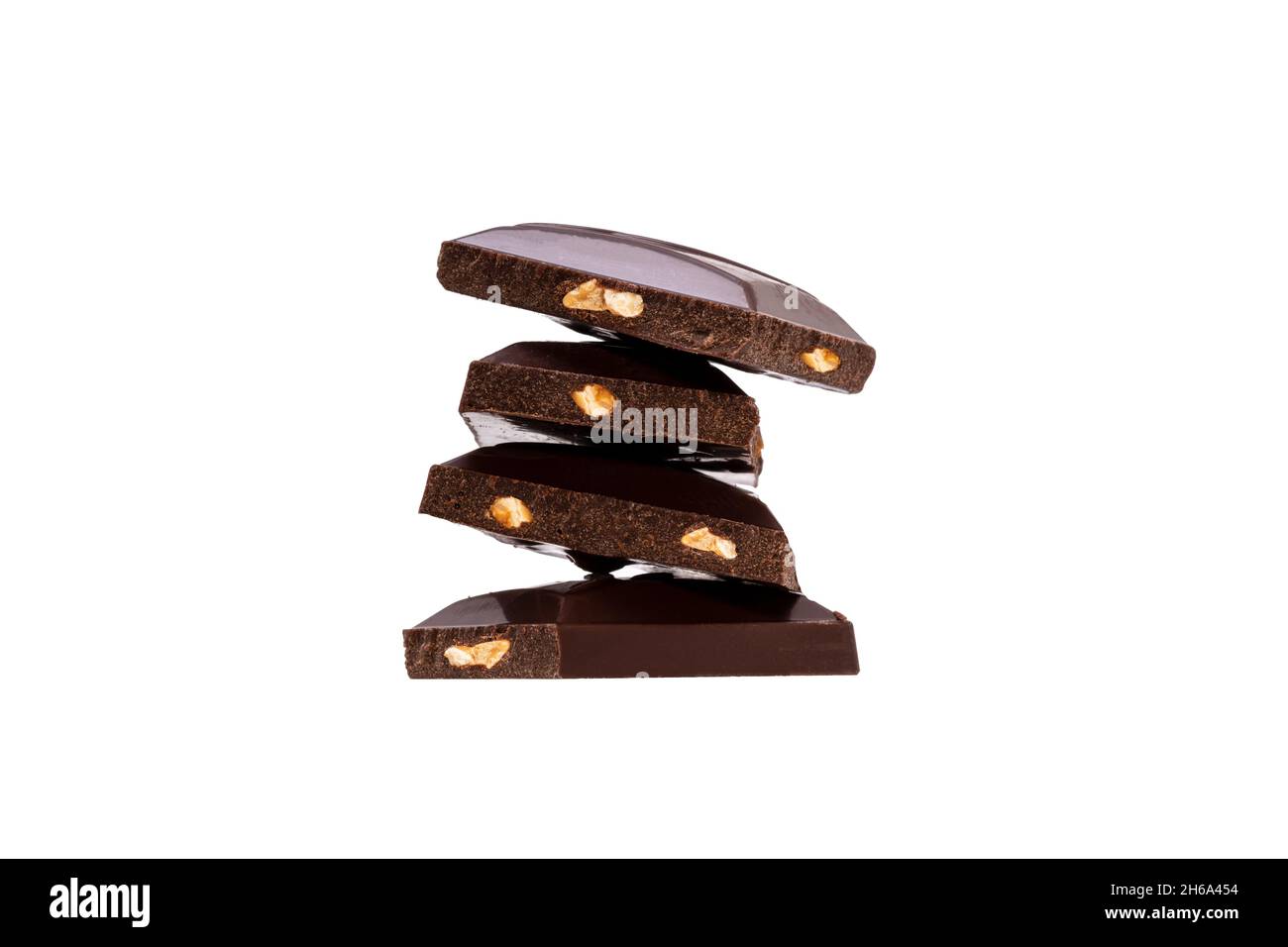 four chocolate bars with nuts on top of each other isolated on white ...