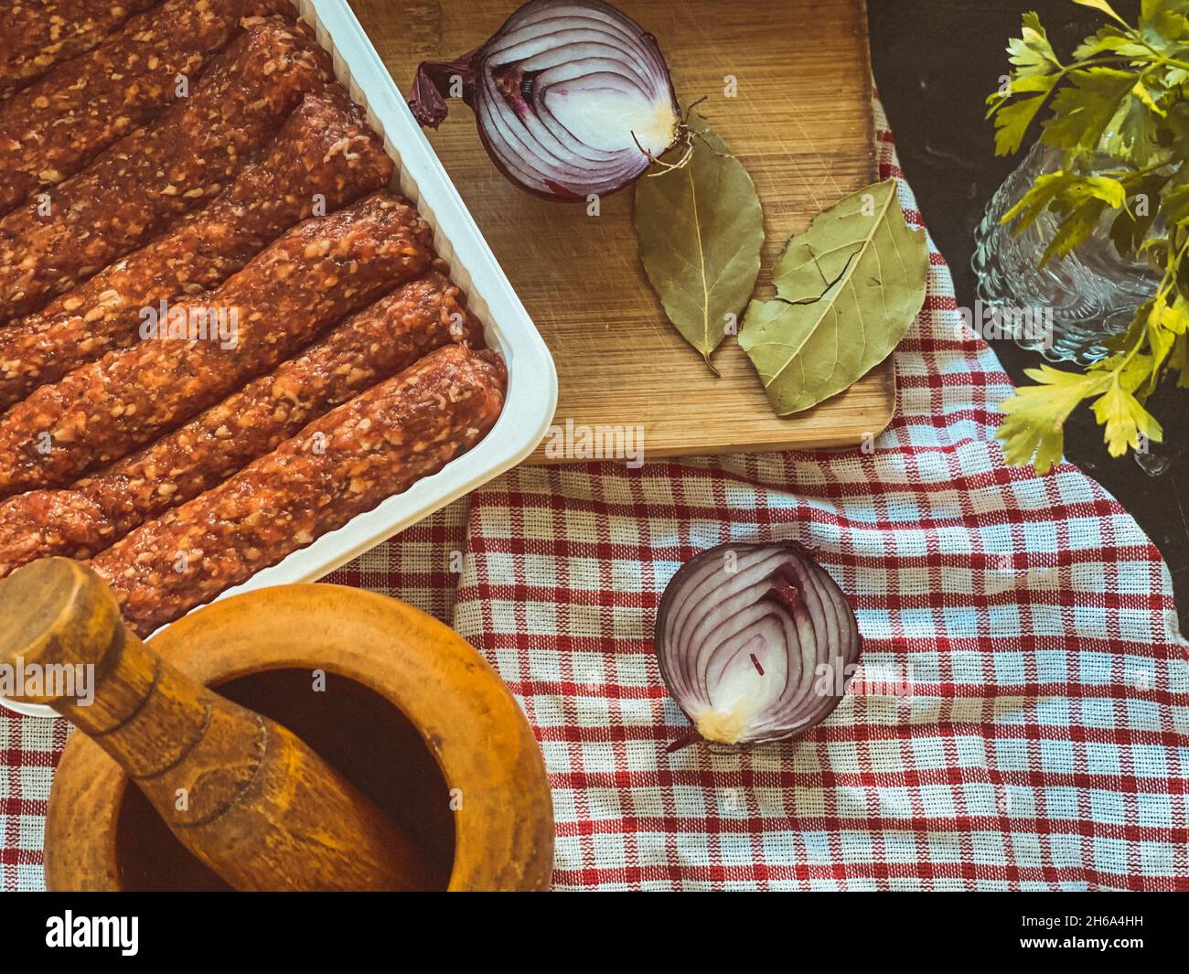 A beautiful view of raw meat in the kitchen with different ingredients ...