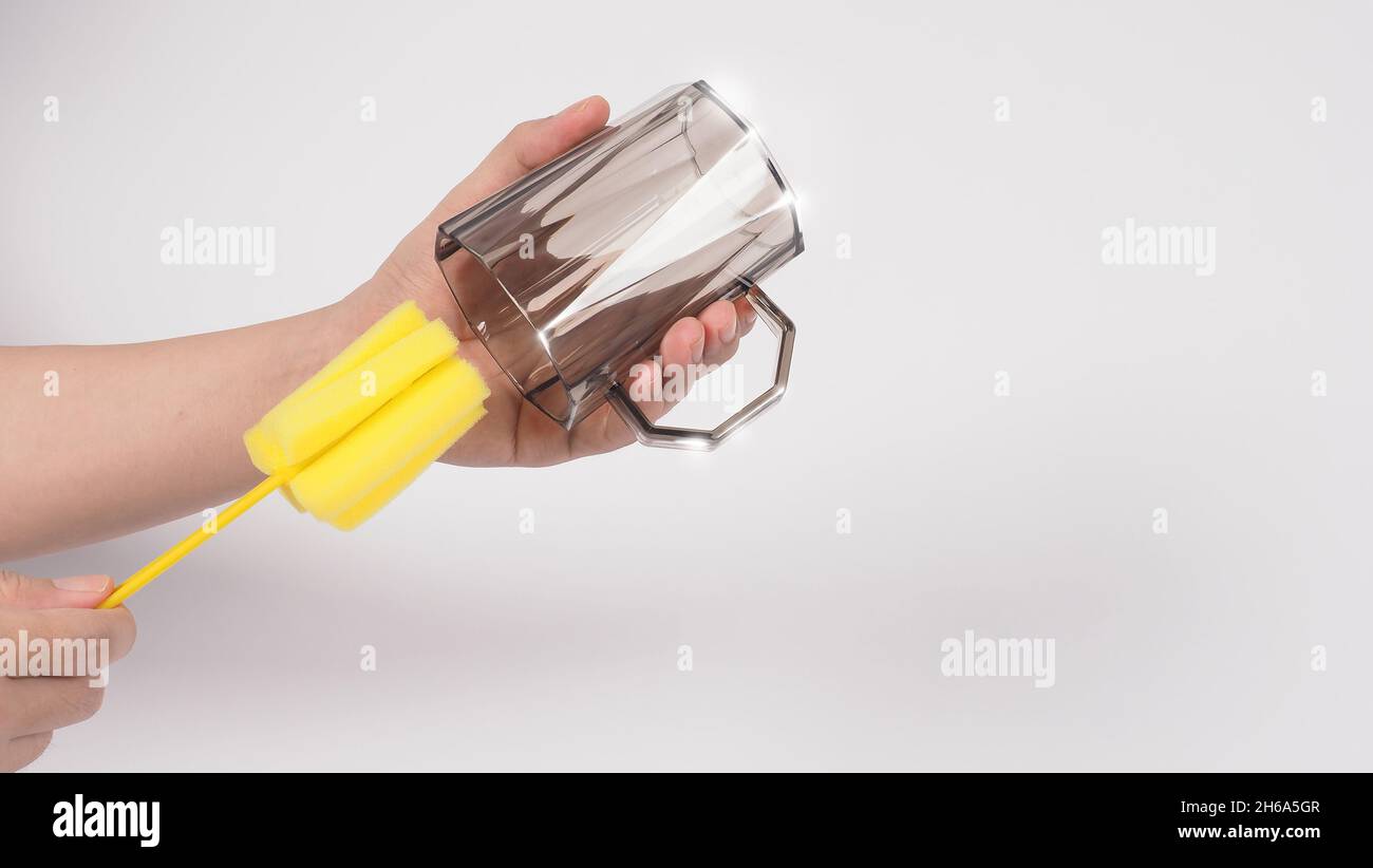 Clean and wash dish concept. Man hand washing drink glass on white ...