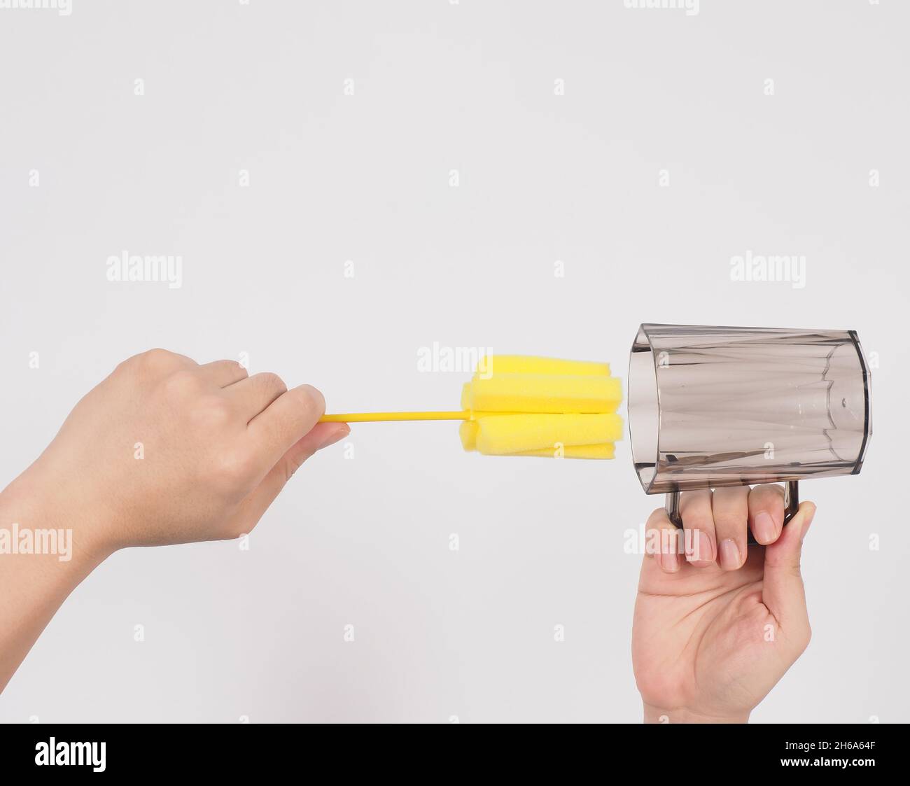 Clean and wash dish concept. Man hand washing drink glass on white ...