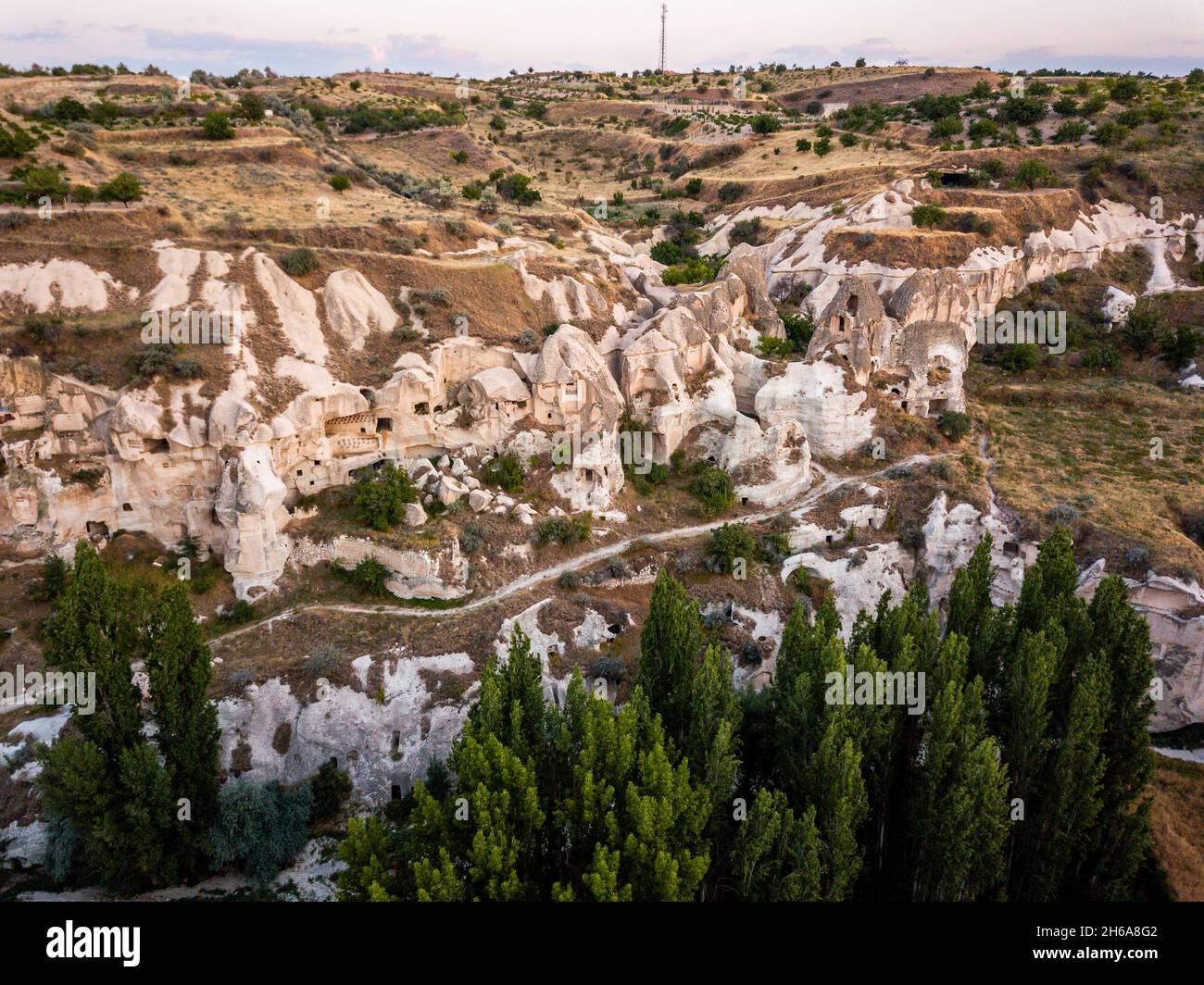 A landscape of hills and rock formations under the sunlight in ...