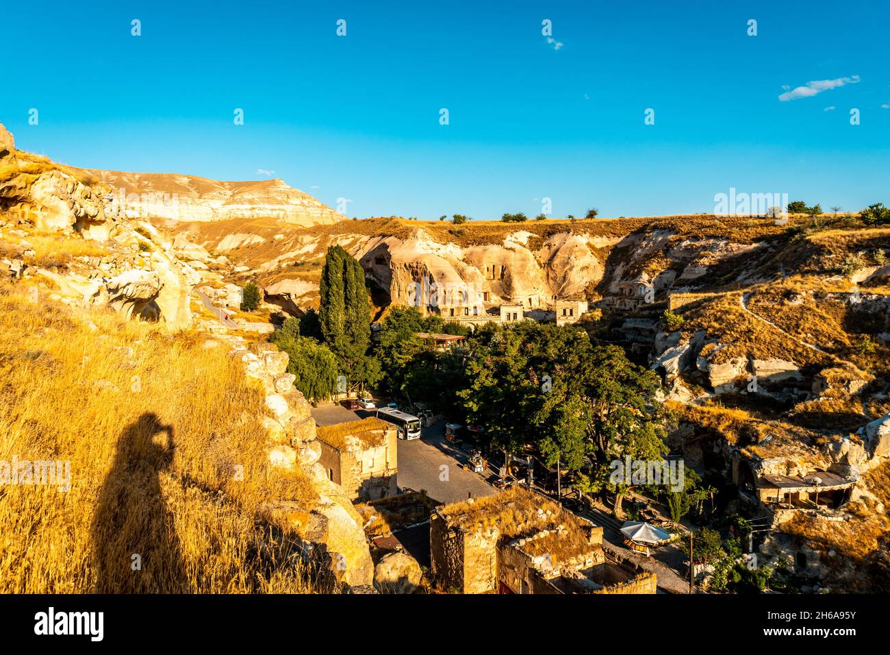 A landscape of rock formations and buildings surrounded by greenery in ...
