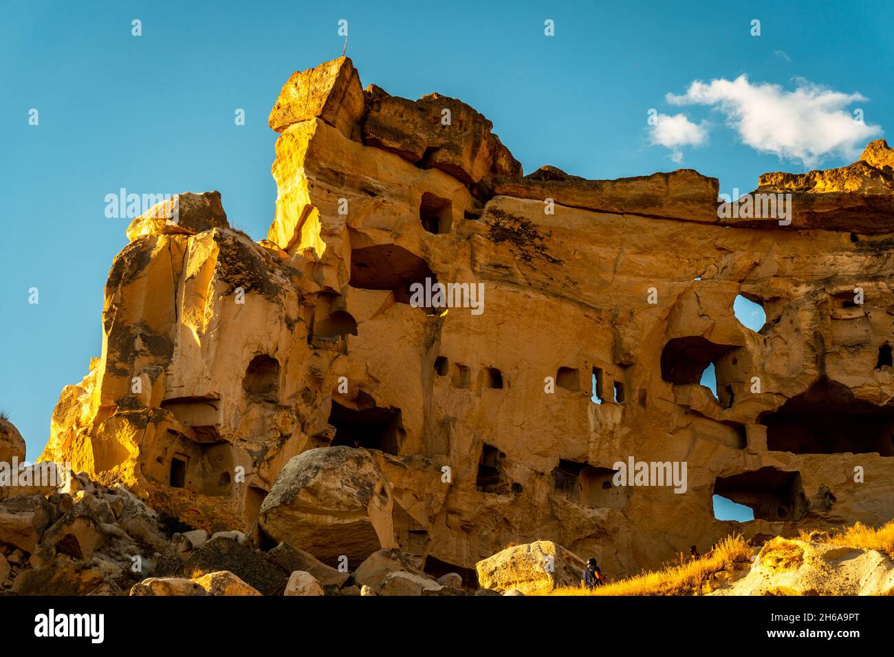 The ancient rock formations with holes on a hill in Cavusin, Cappadocia ...