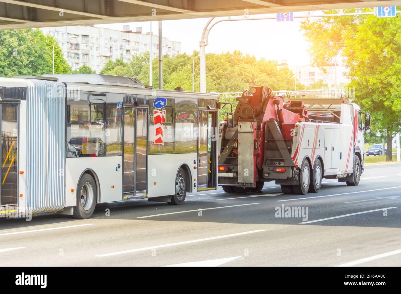 Repair and recovery vehicle evacuation, rear view towing a broken city ...