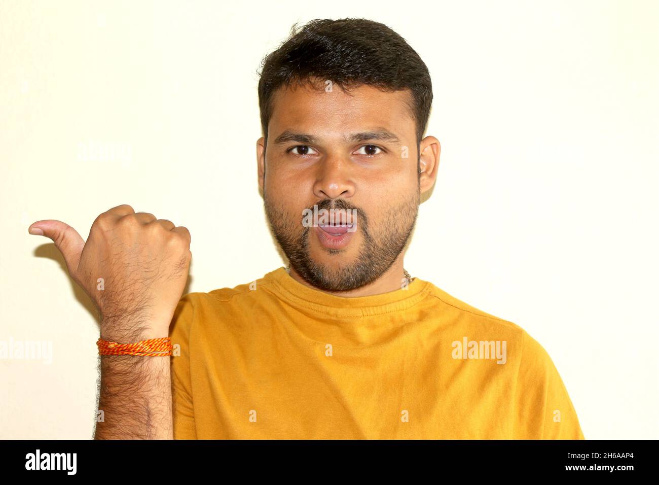 Photo of shocked handsome guy looks with jaw dropped out at camera ...