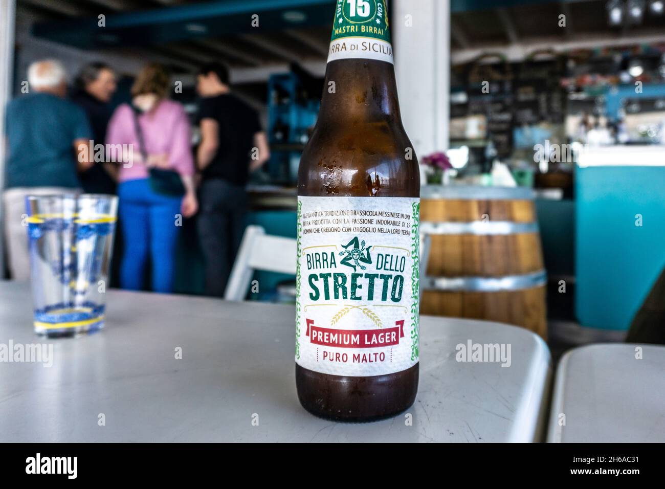 A bottle of Birra Stretto pure malt premium lager on a table in a bar ...