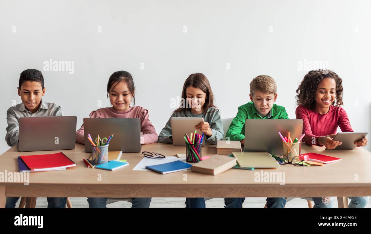 Multicultural School Children Using Laptop Computers Learning Sitting ...