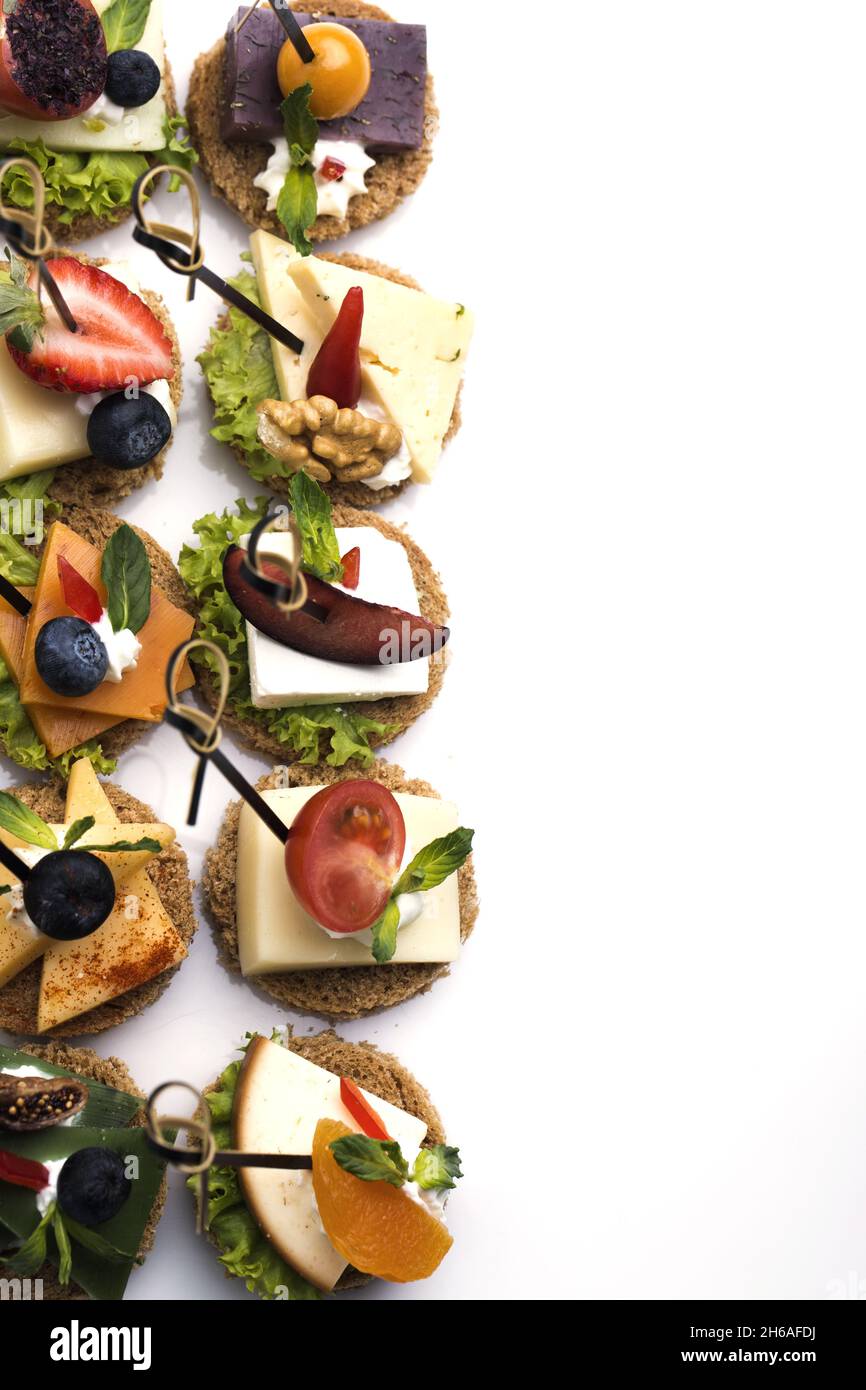 A vertical shot of different cheese canapes isolated on white ...