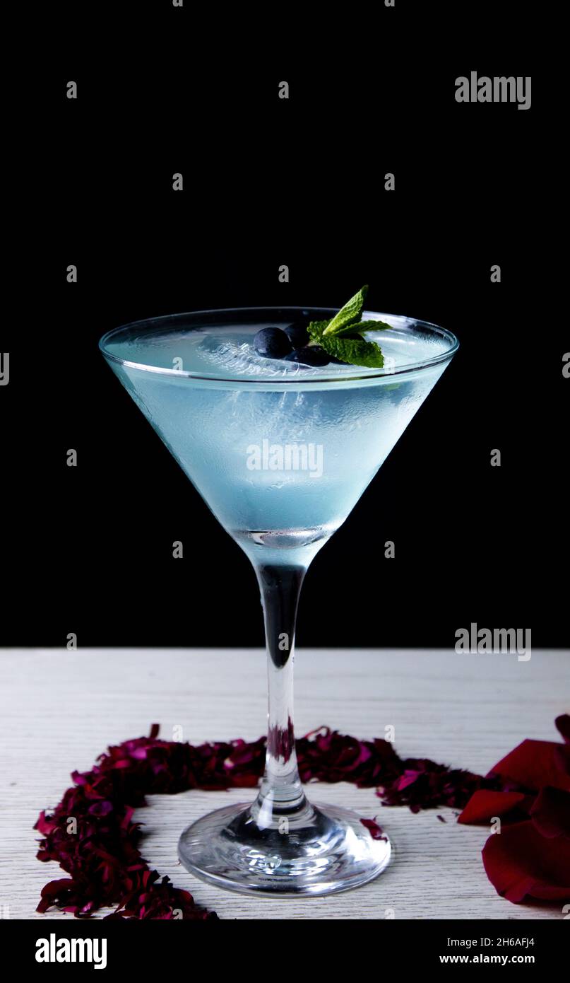 A vertical shot of a blue alcoholic cocktail on a dark background Stock ...