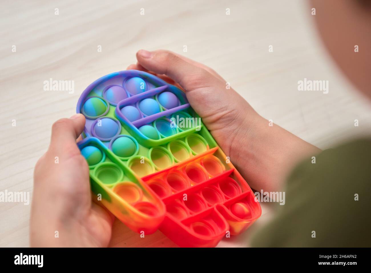 Kids hands push sensory pop it. Colorfull antistress toys, simple ...