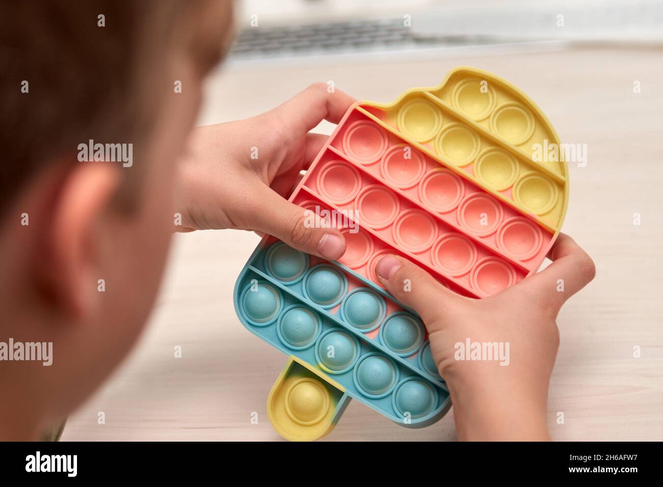 Kids hands push sensory pop it. Colorfull antistress toys, simple ...