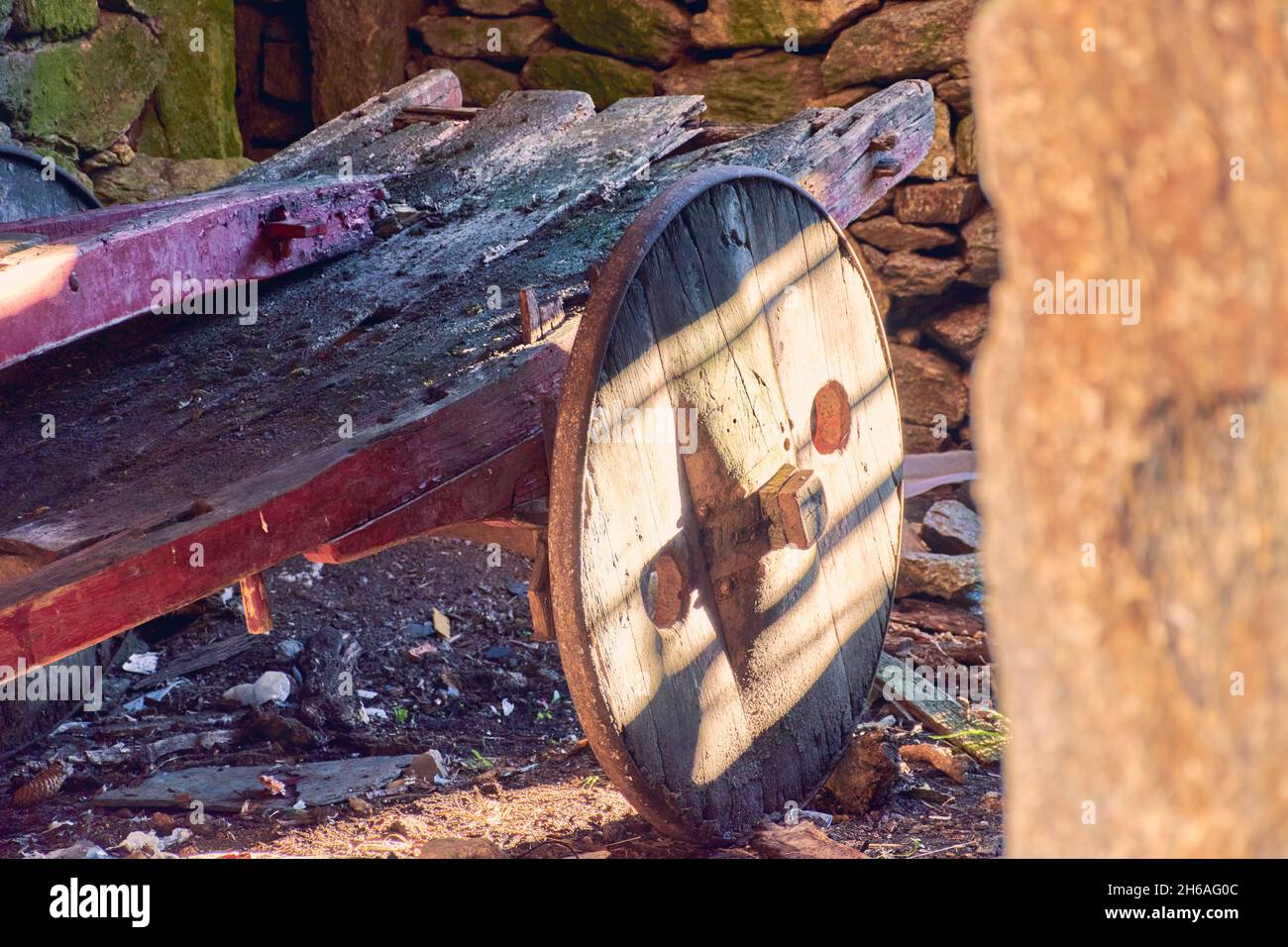 An old ancient wooden car wheel on the sand in the daytime Stock Photo ...