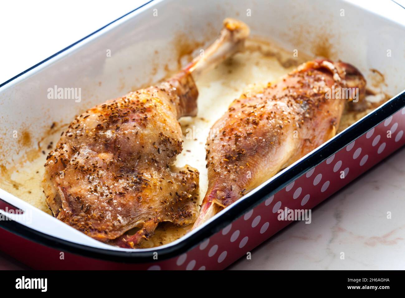baked goose legs with cumin in frying pan Stock Photo - Alamy