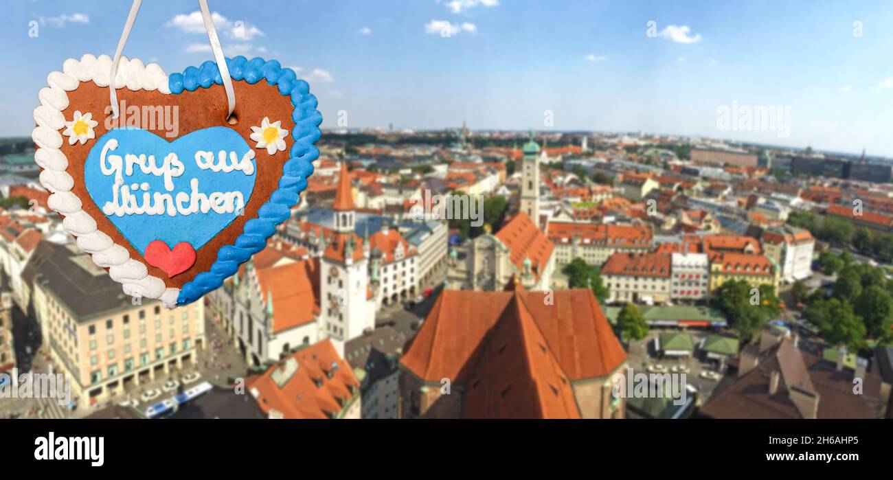 Focus on gingerbread heart with written slogan "Greetings from Munich ...