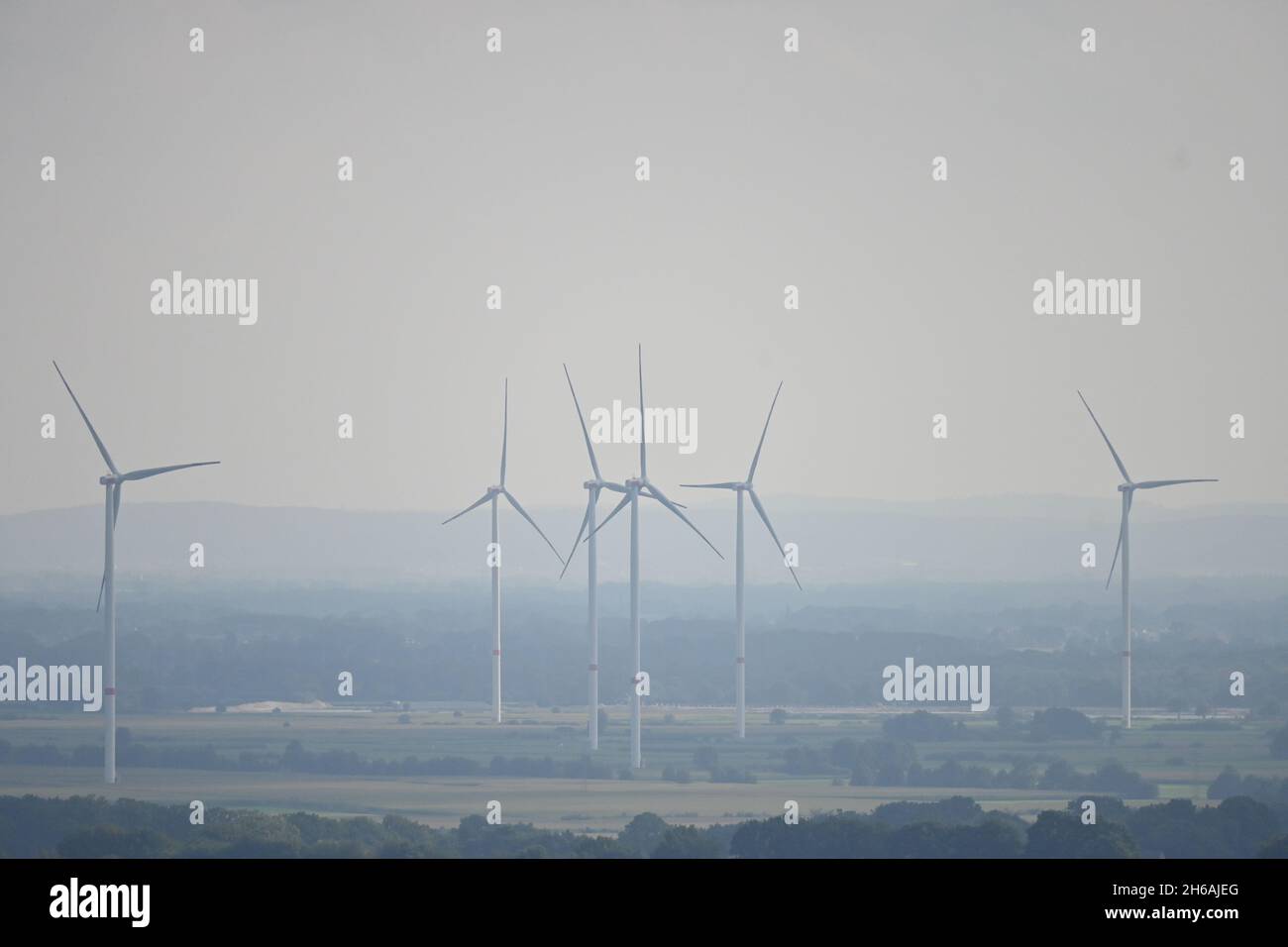 A beautiful scene of wind turbines in a field through the clouds Stock ...