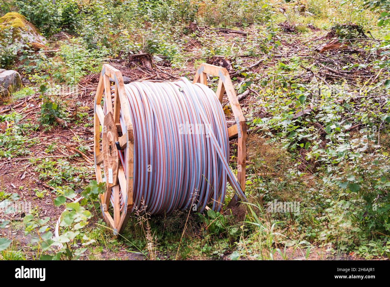 A roll of fiber optic cables; laying trend-setting cables Stock Photo ...