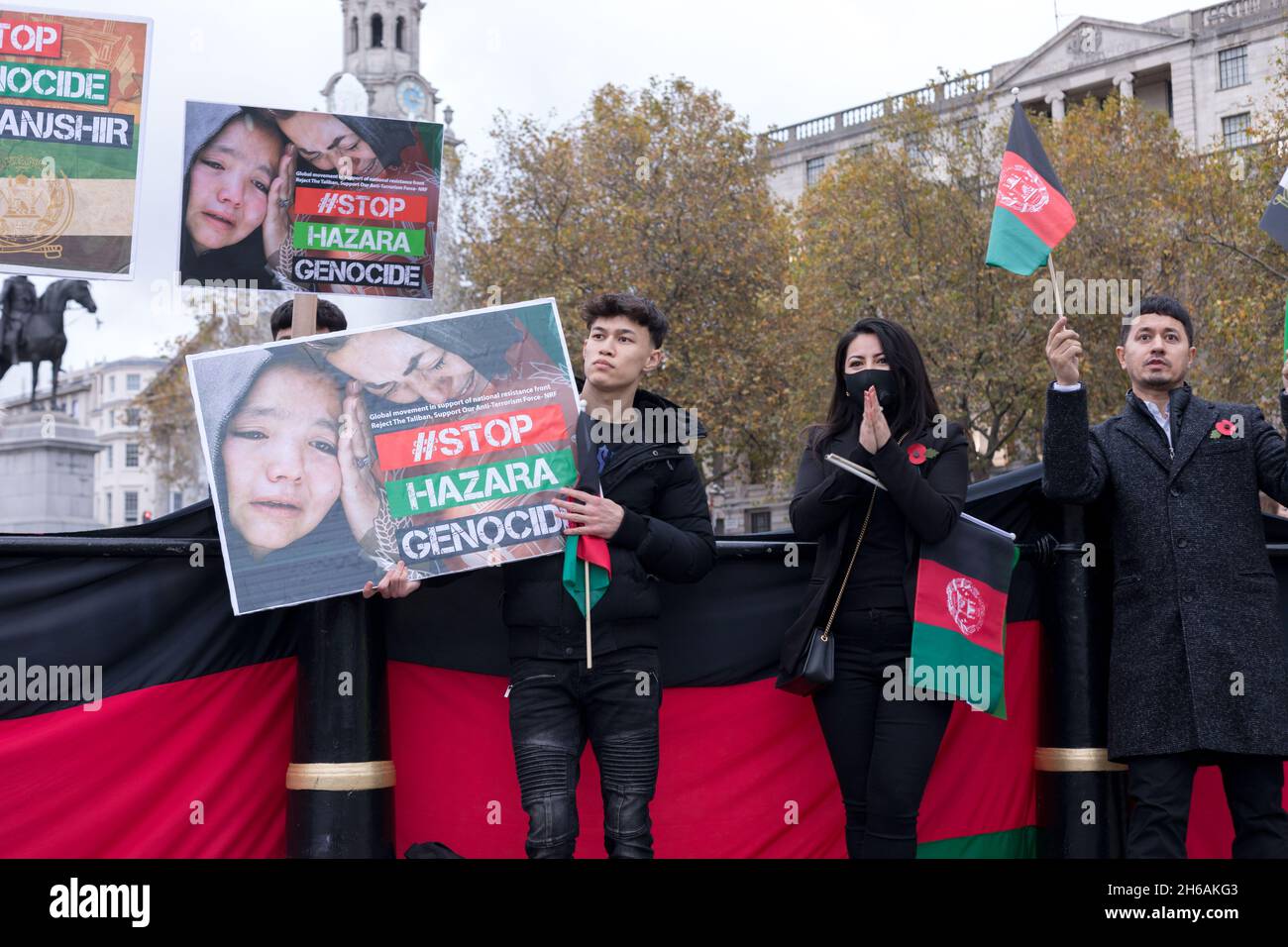 Protestors hold Afghanistan flags and placards that read 'stop Hazara ...