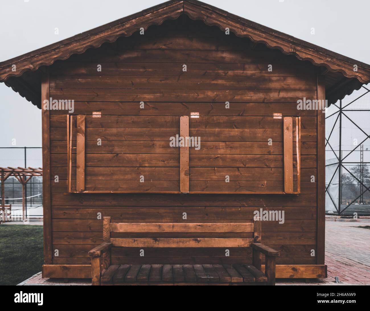 Wooden house and bench Stock Photo - Alamy