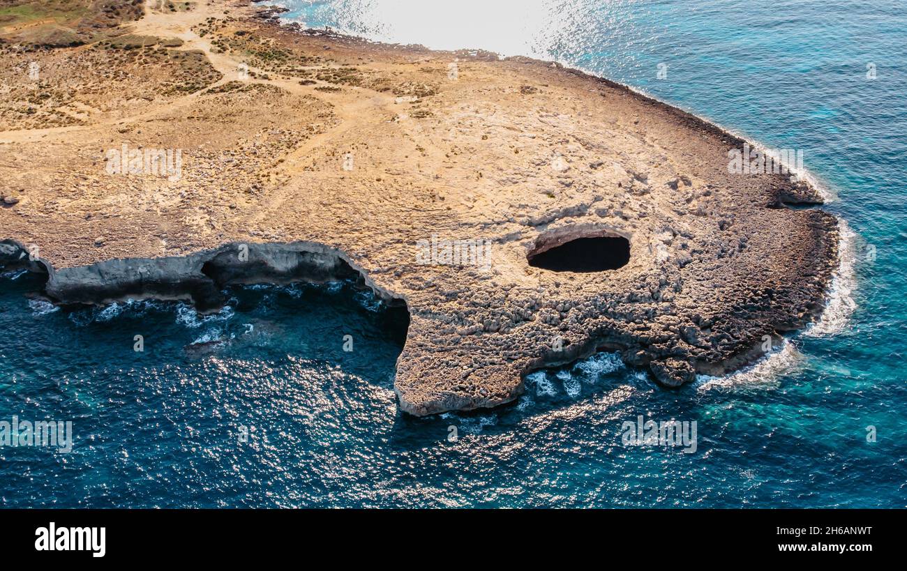 Aerial view of Ahrax fallen cave,Coral Lagoon,Malta.Hole in the middle ...